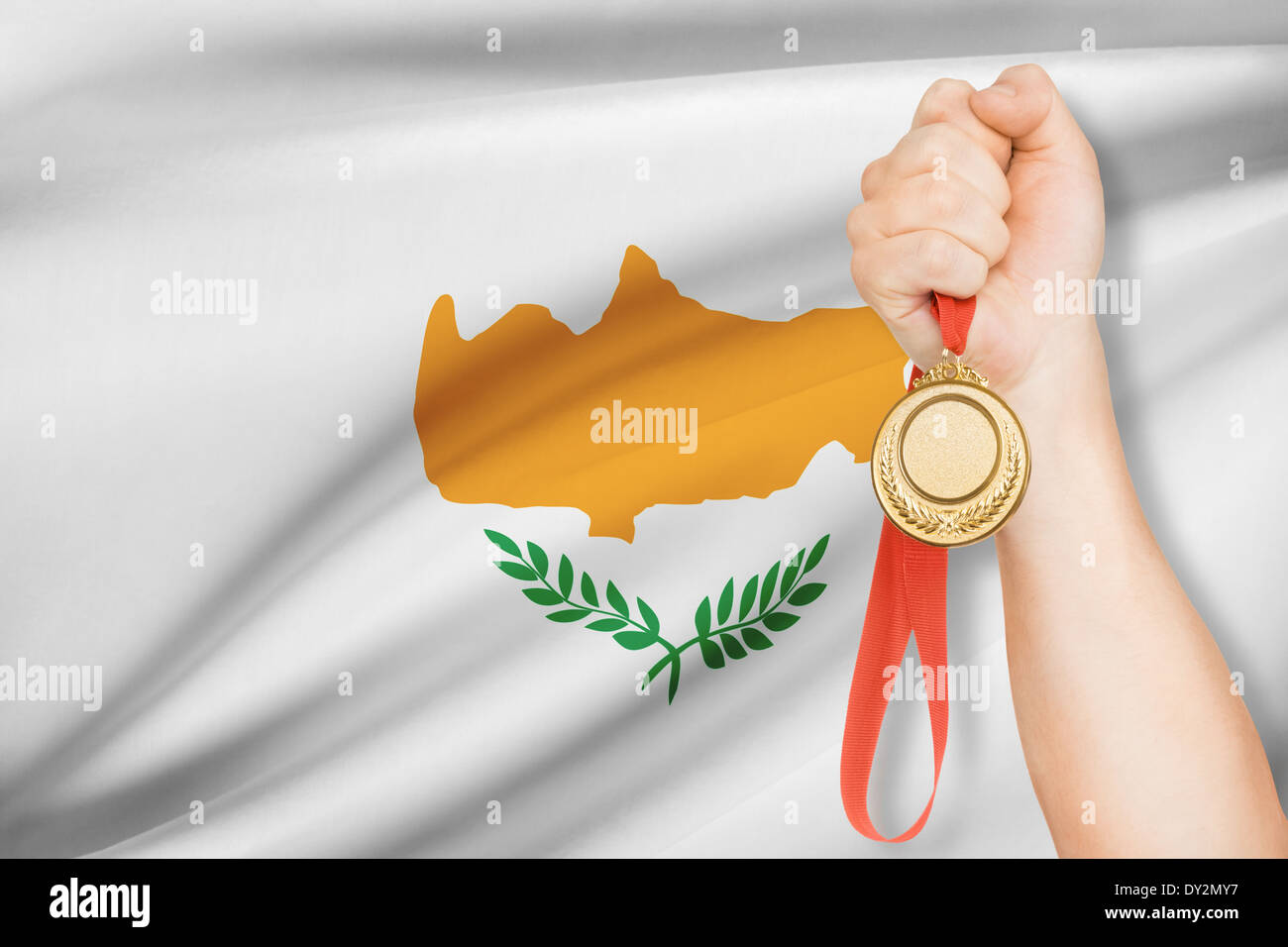 Sportsman holding gold medal with flag on background - Republic of ...