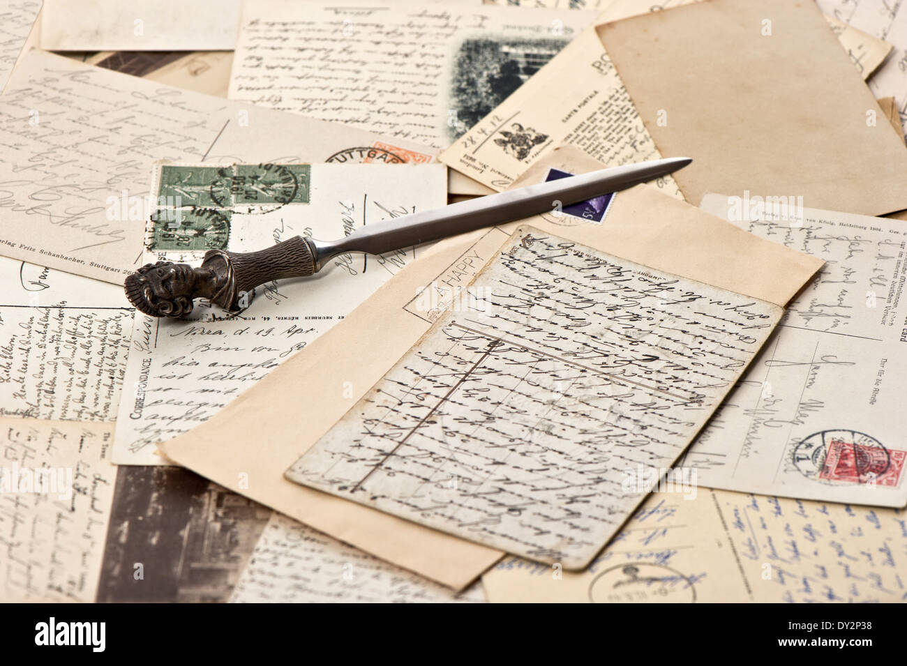 old papers and post cards with letter opener. vintage grunge background ...