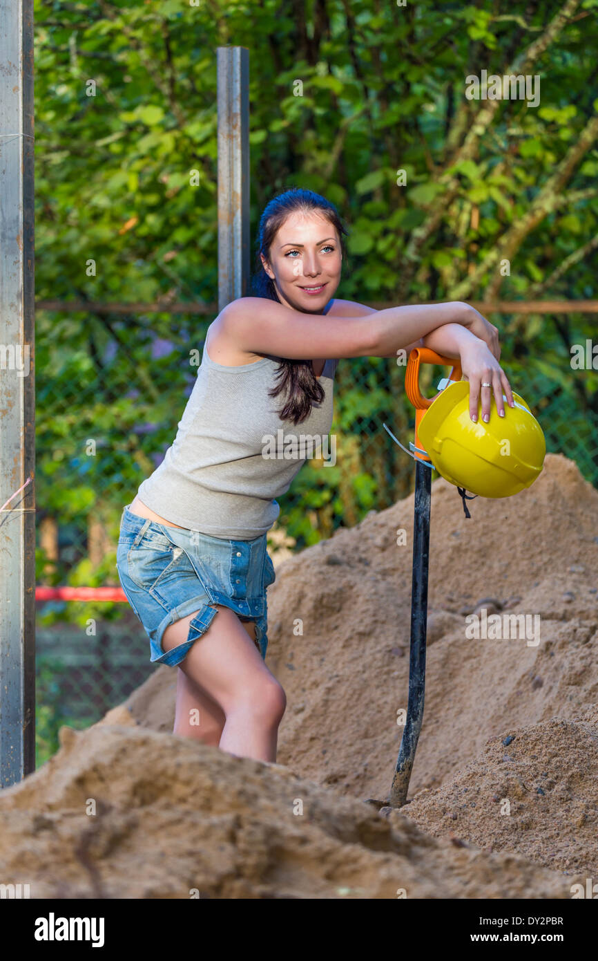 Pretty young woman builder digging a shovel industrial teamwork Stock ...