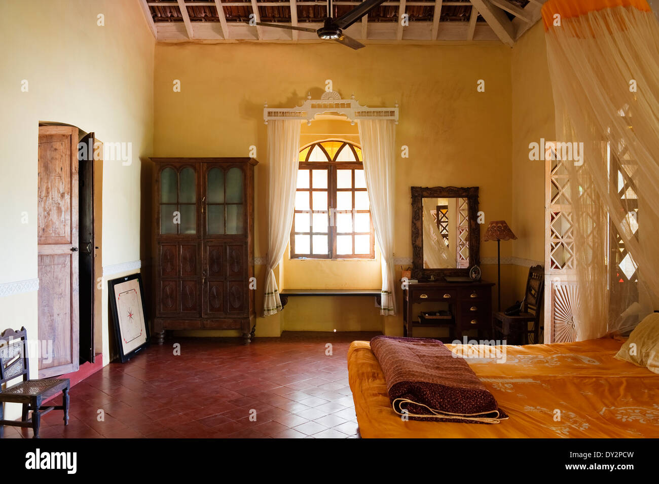 Dark wood cabinet and dressing table in bedroom of Goan home Stock ...
