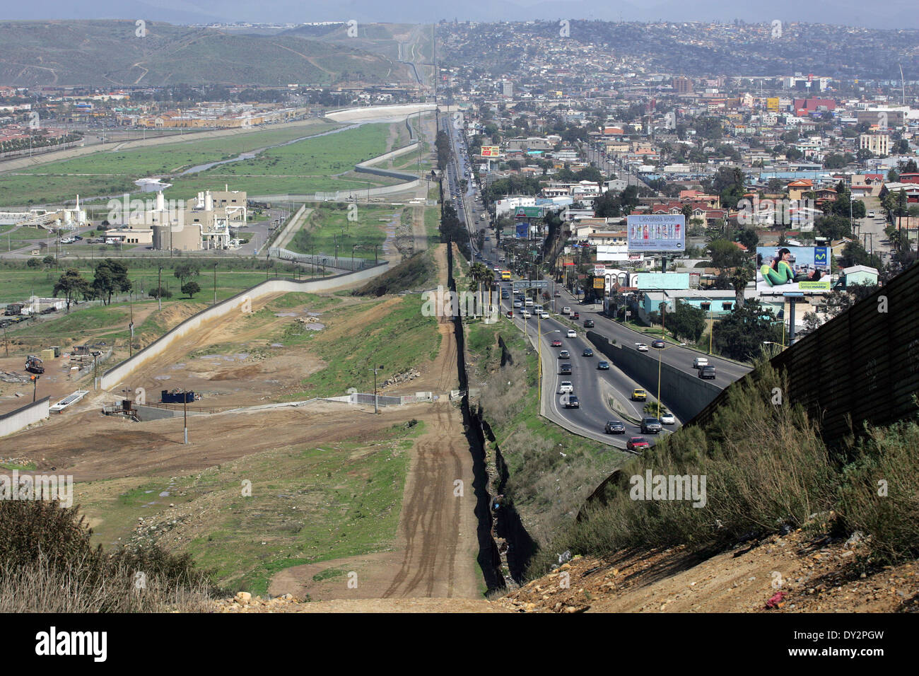 Border fence separating the Mexican city of Mexicali on the right from ...
