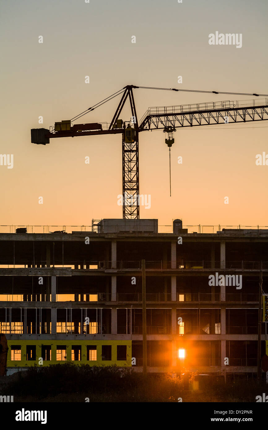 Construction cranes with sunset background Stock Photo - Alamy