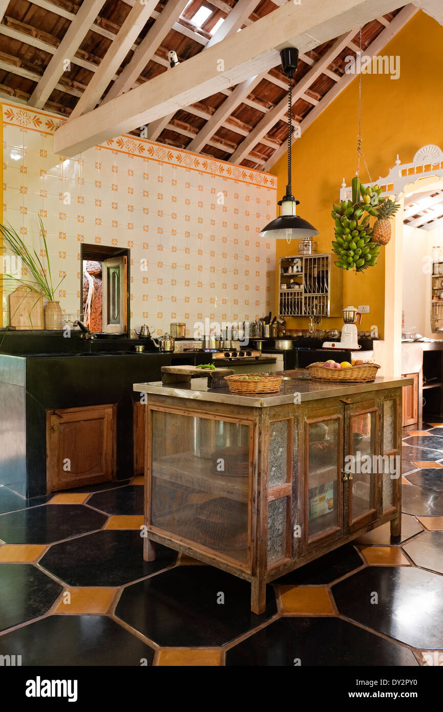 Freestanding unit on black and yellow tiled floor of Goan kitchen Stock ...