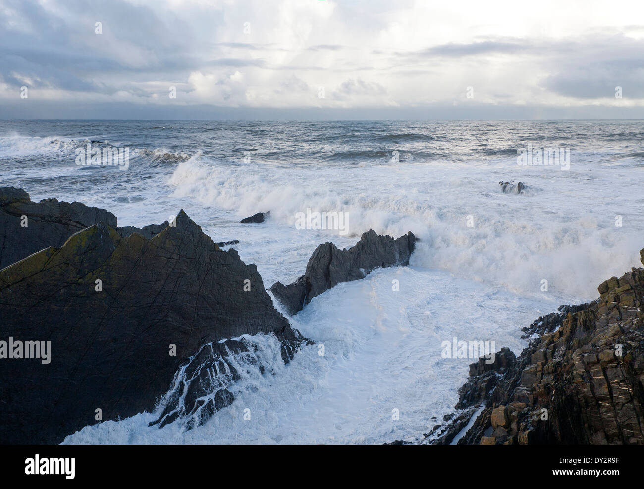 Large Atlantic storm waves crashing onto jagged rocky coast at Hartland ...
