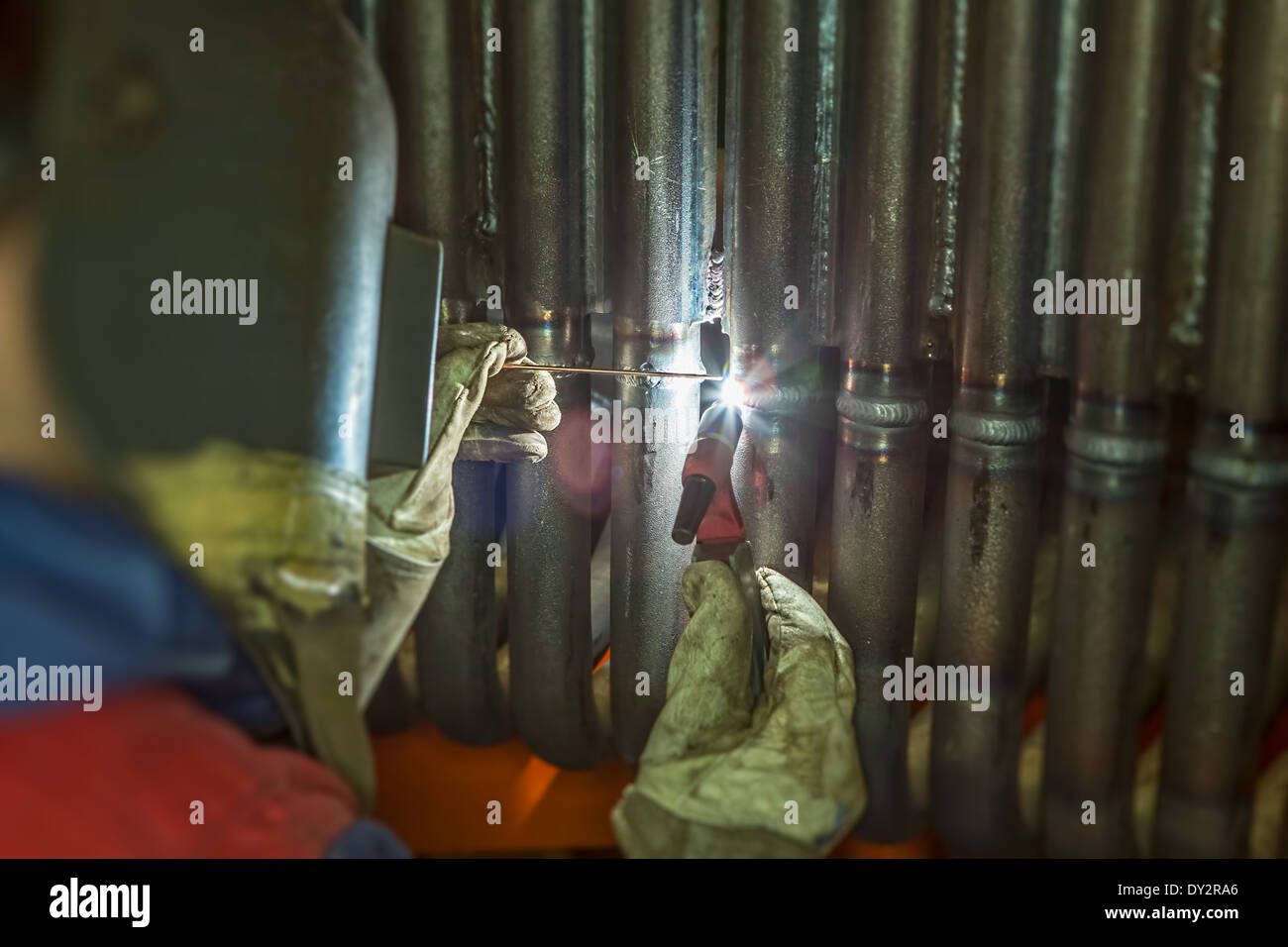 Welder welding metal pipes Stock Photo - Alamy
