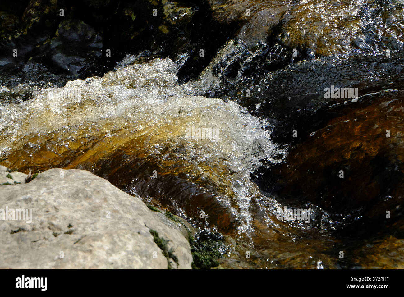 Tumbling water over rocks Stock Photo - Alamy