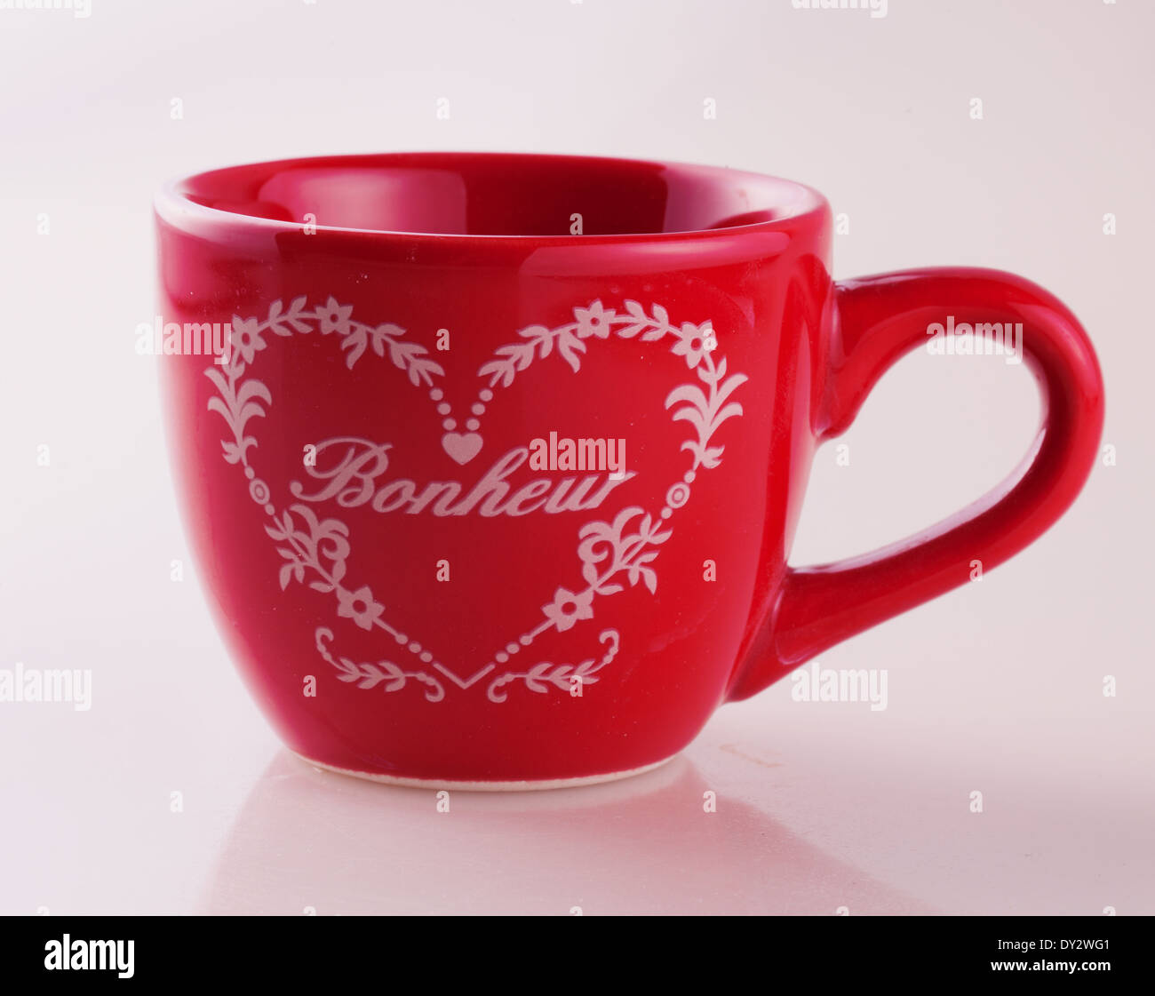 A red cup with text "bonheur" on the side Stock Photo - Alamy