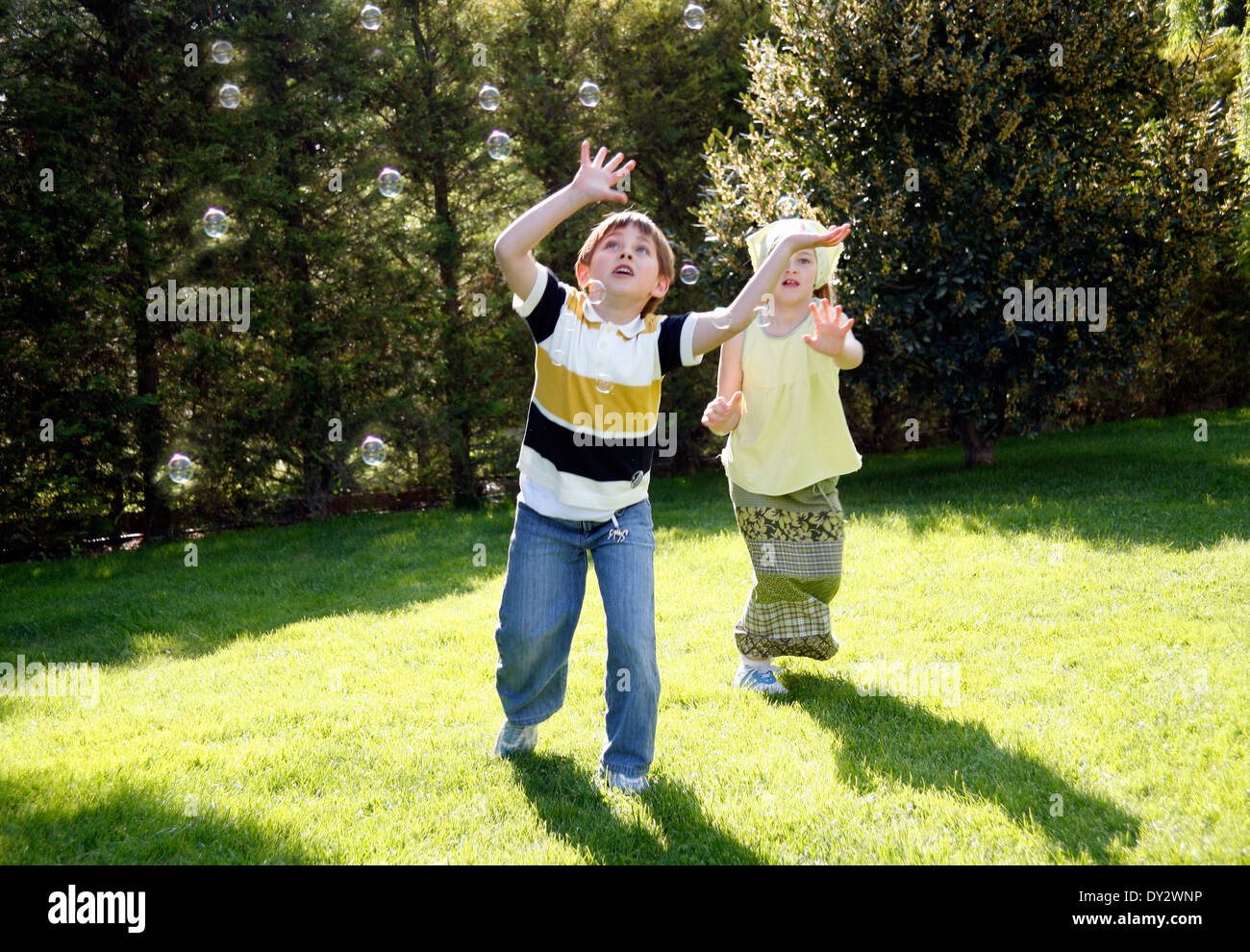 Girl chasing bubbles hi-res stock photography and images - Alamy