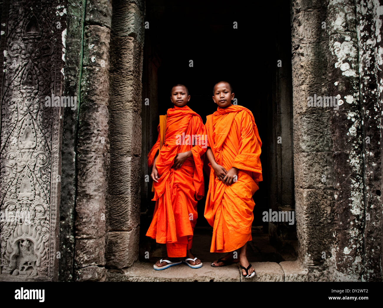 Two young monks pose for a portrait at the Bayon temple in Angkor Thom ...