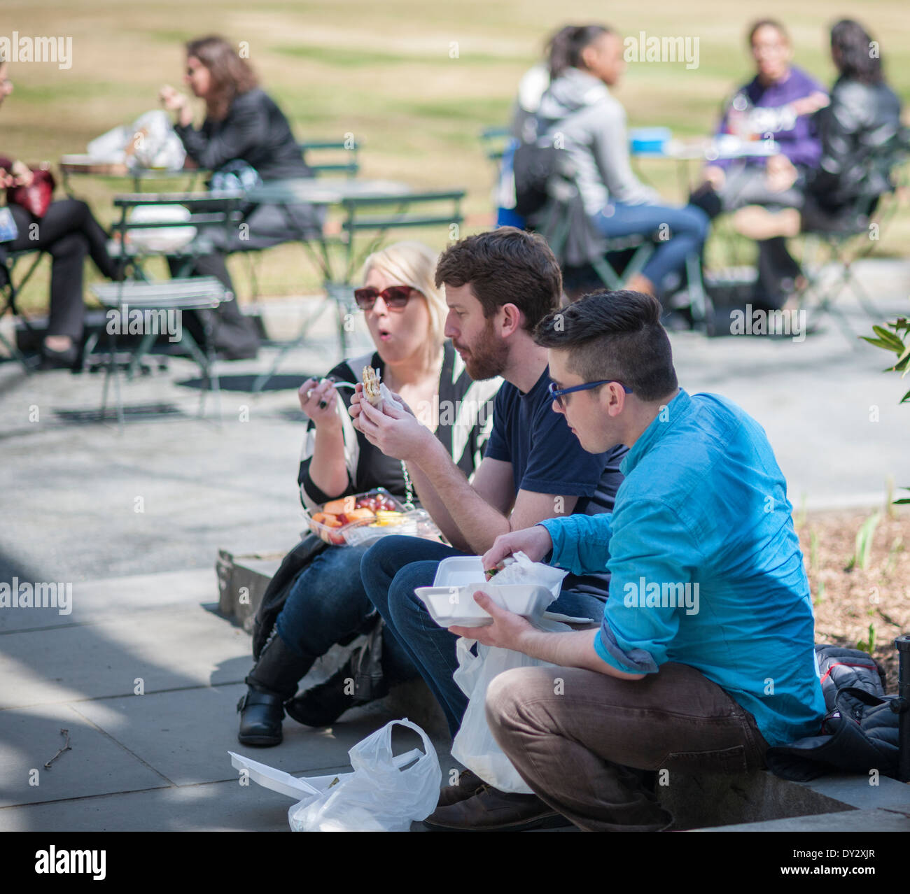 Visitors eat lunch in Bryant Park in New York City while enjoying the ...