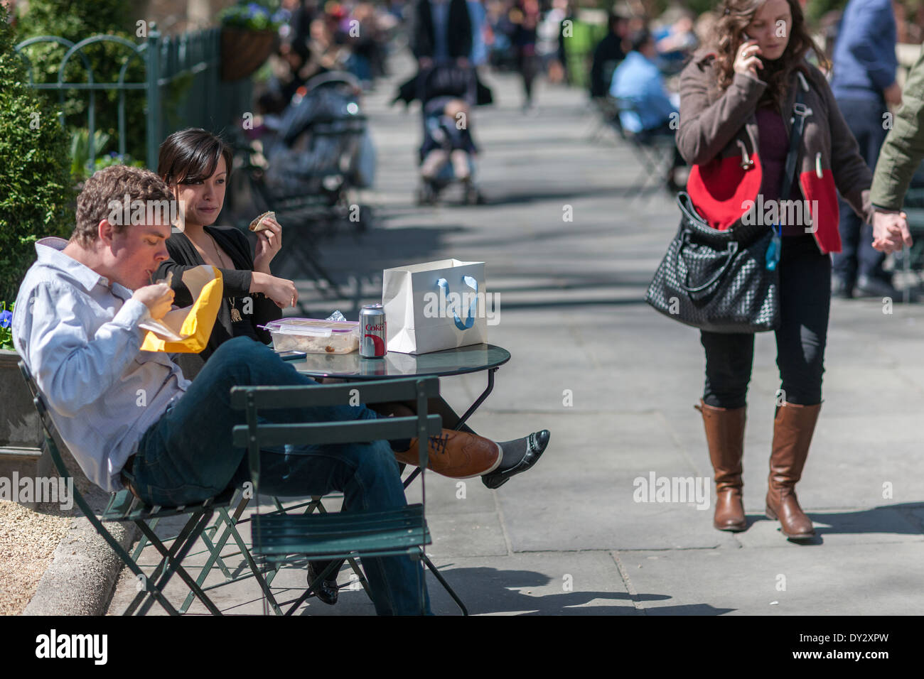 Visitors eat lunch in Bryant Park in New York City while enjoying the ...