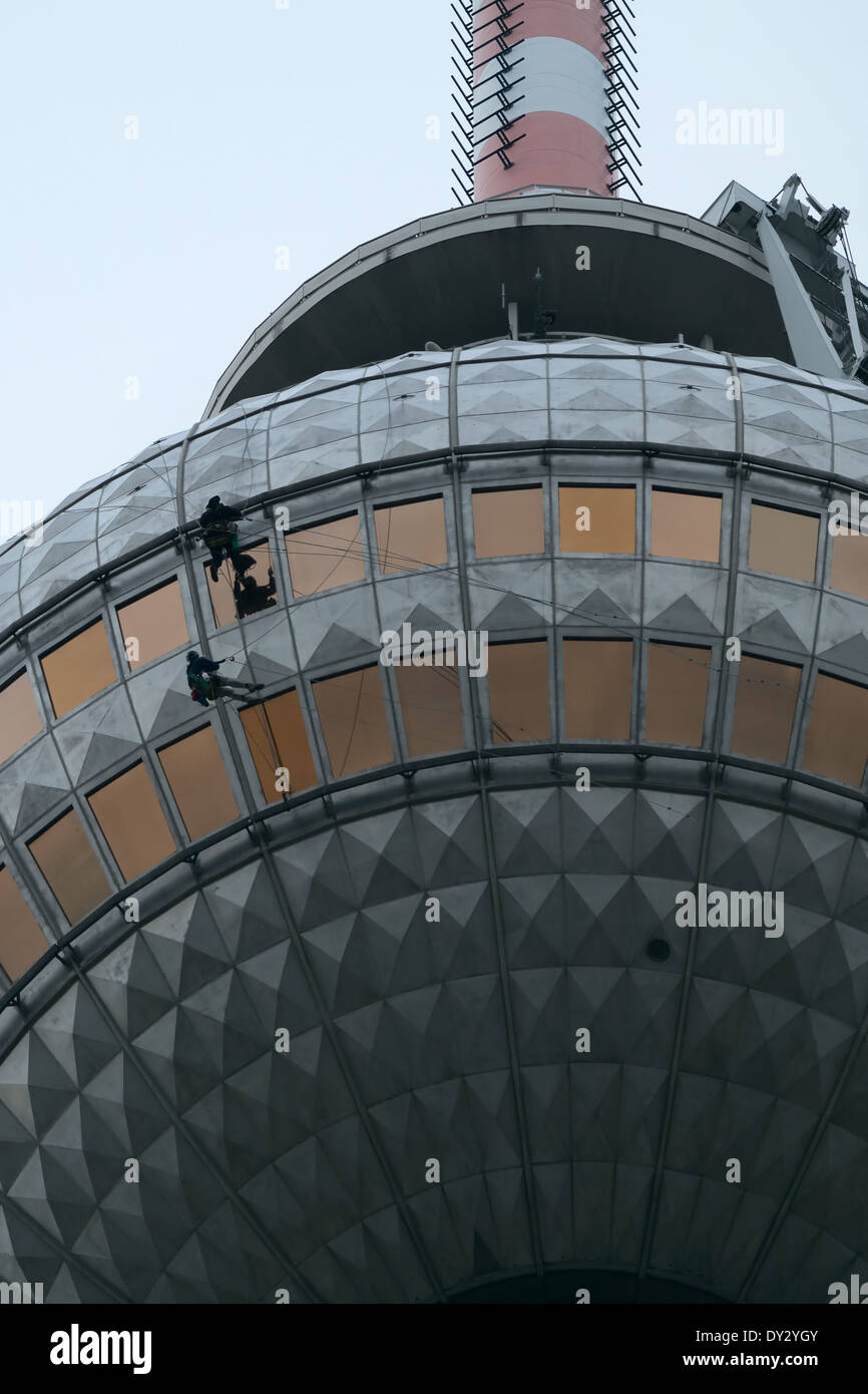 Rope access. Climbers wash windows at the Berlin TV Tower. Berlin ...
