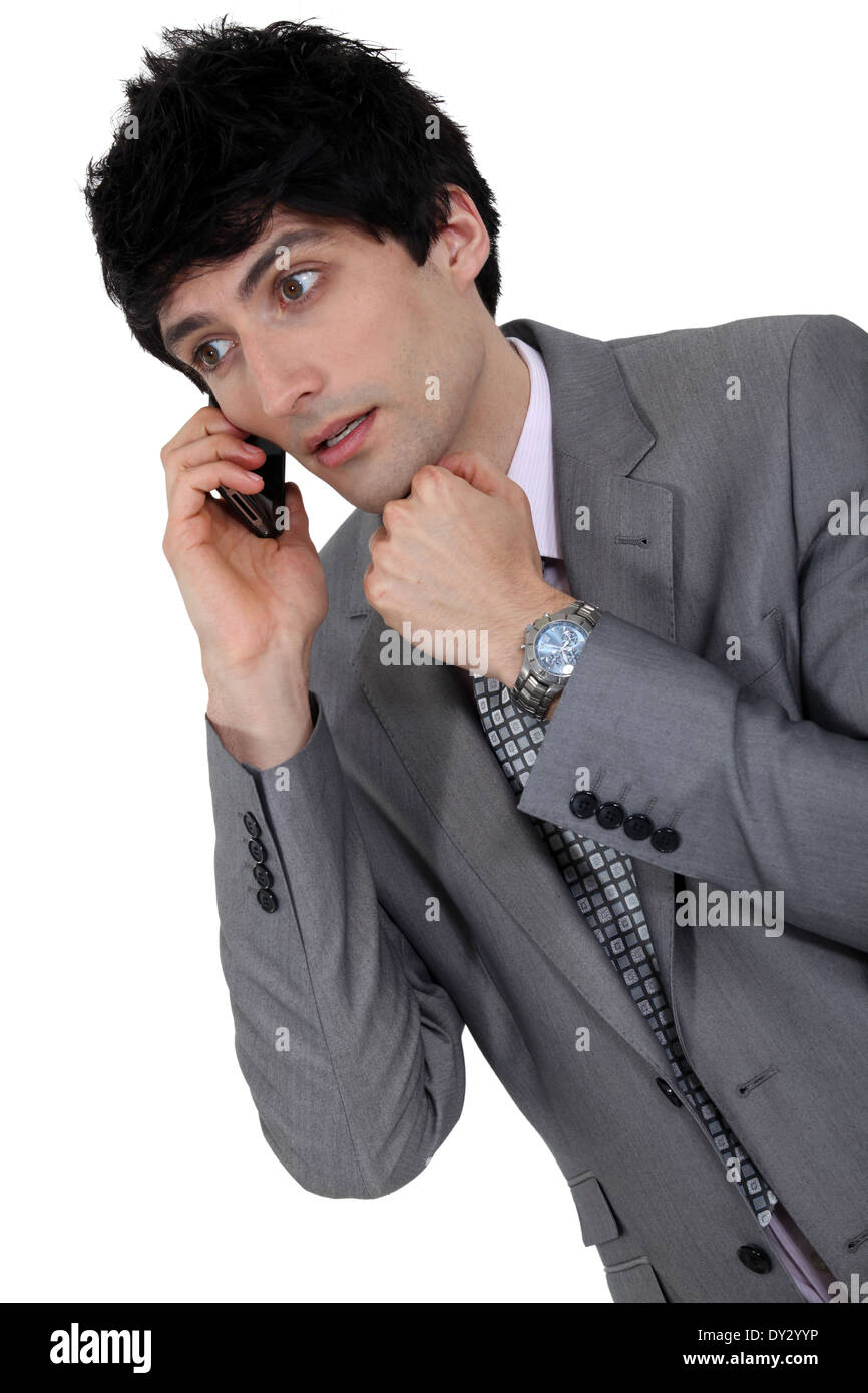 confused businessman talking on his cell Stock Photo - Alamy