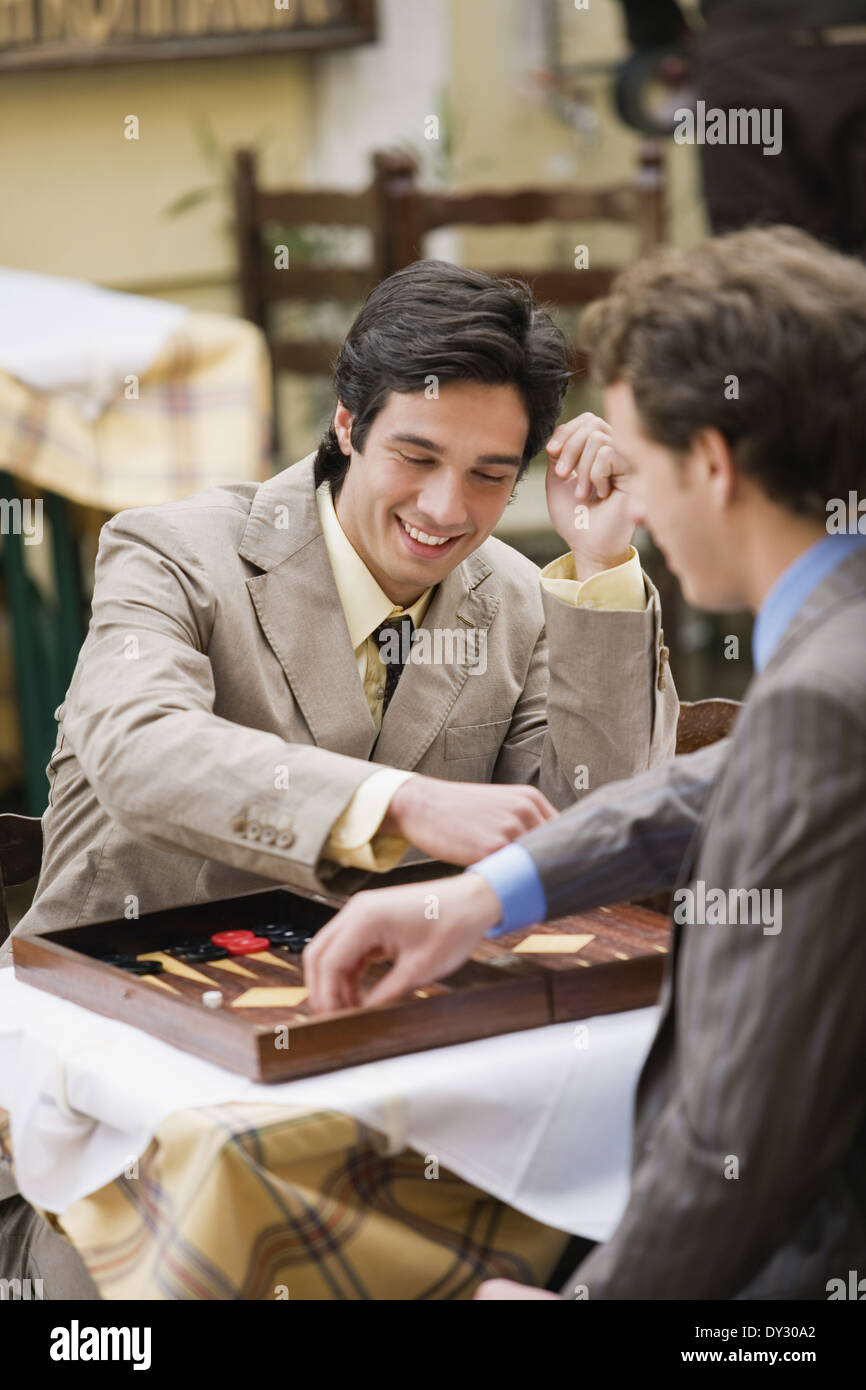 Two businessmen playing backgammon Stock Photo - Alamy