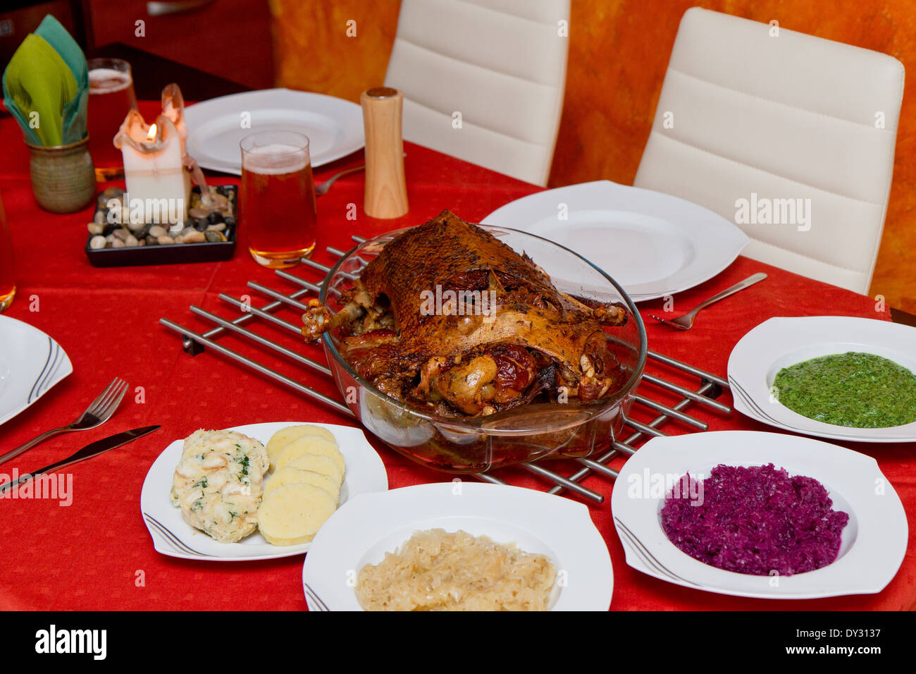fried goose on a plate on a set table Stock Photo - Alamy