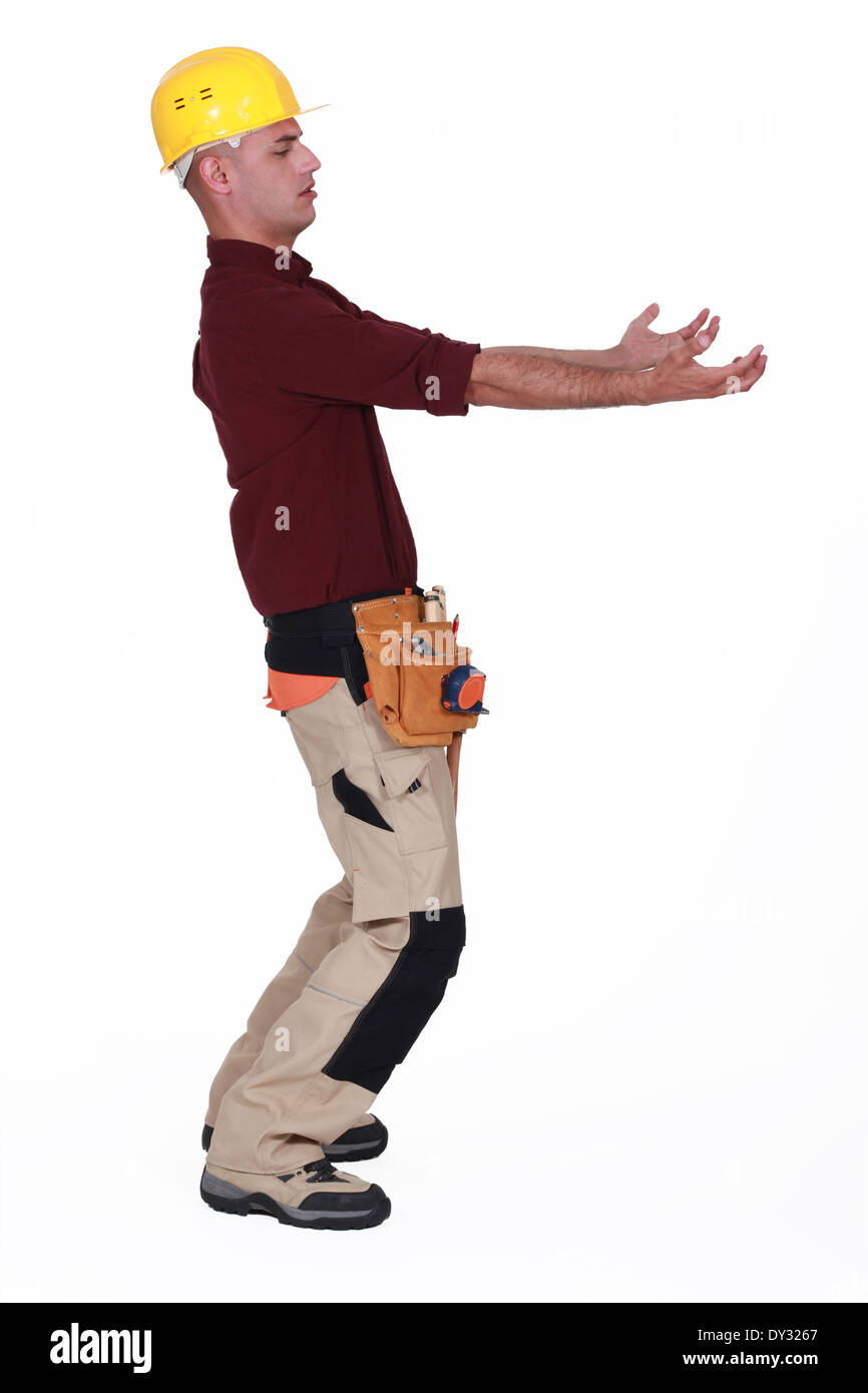 Man struggling to lift heavy object Stock Photo - Alamy