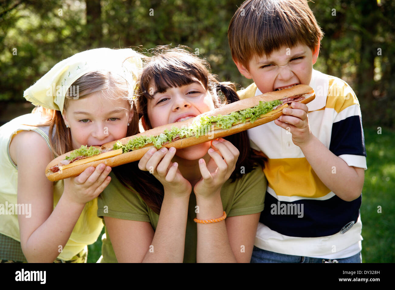 Three children sharing hi-res stock photography and images - Alamy