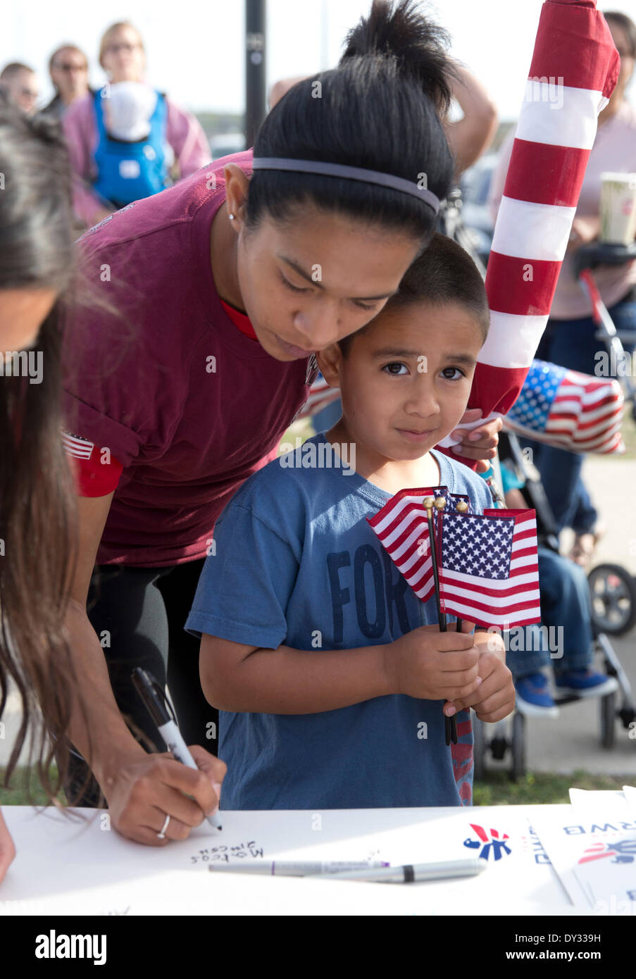 Young woman signs memorial card in support of Fort Hood Army Post ...