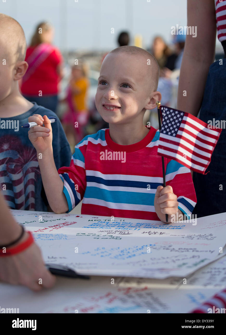 Boy signs memorial card in support of Fort Hood Army Post soldiers and ...
