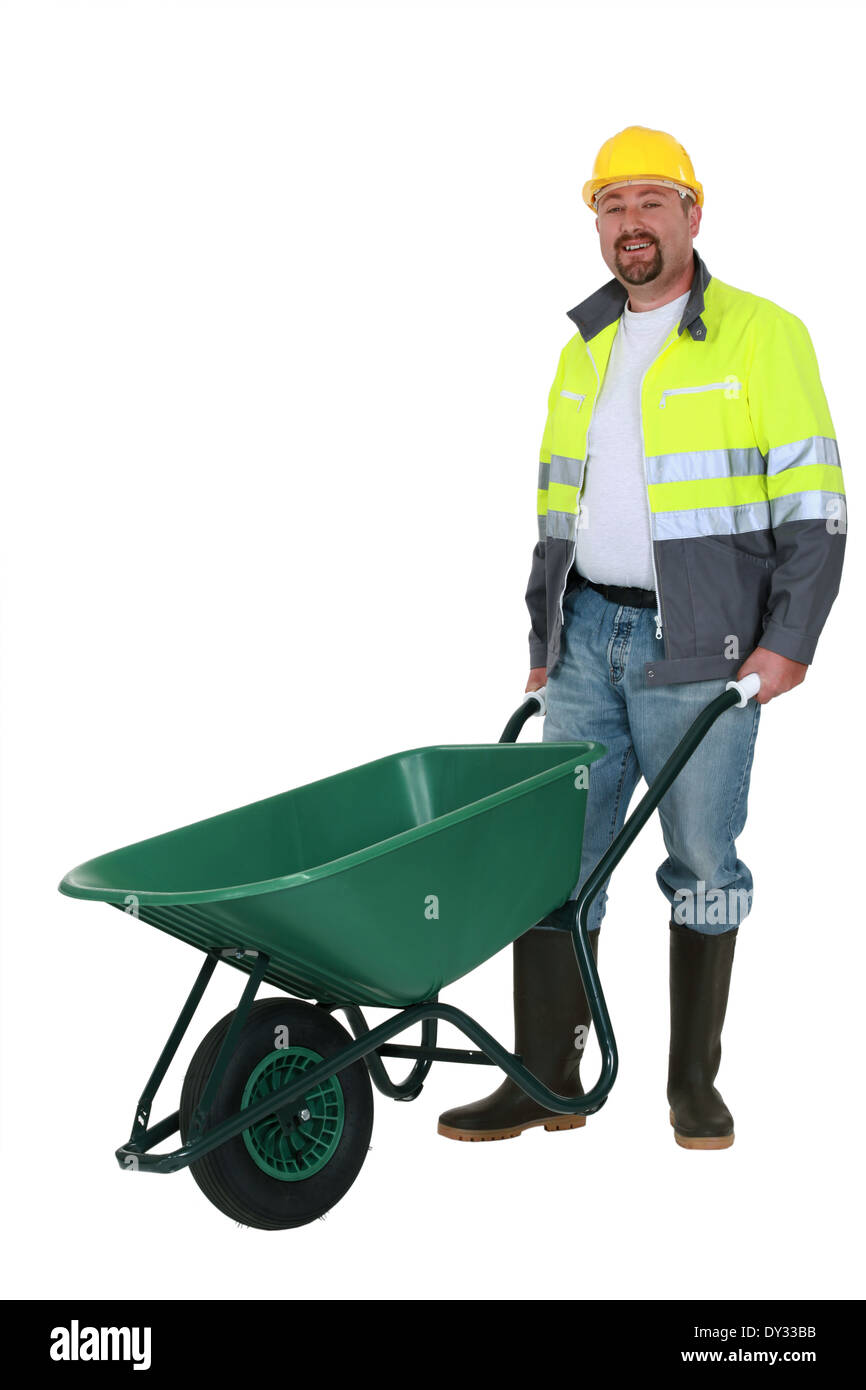 Worker with wheelbarrow Stock Photo - Alamy