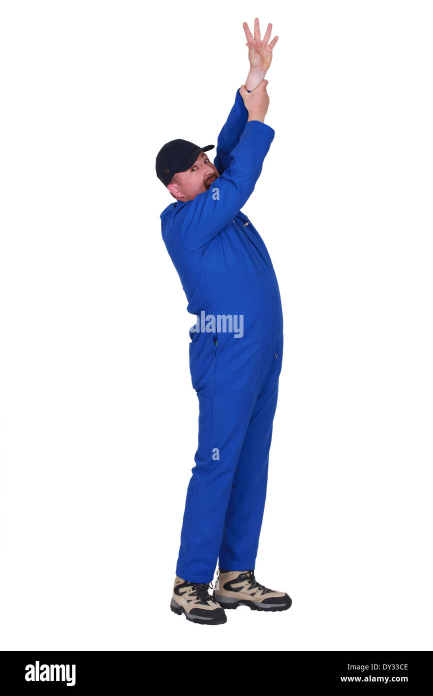 Manual worker reaching up Stock Photo - Alamy