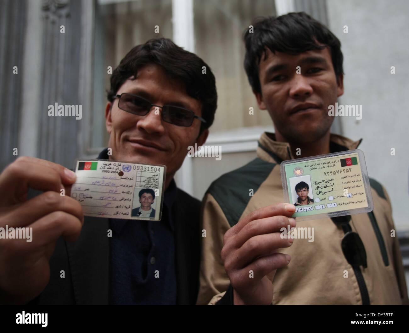 Kabul, Afghanistan. 5th Apr, 2014. Afghan men hold their identity cards ...