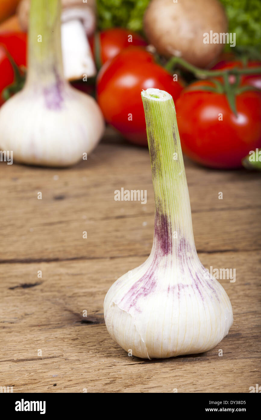Garlic bulb in front of vegetable background Stock Photo - Alamy