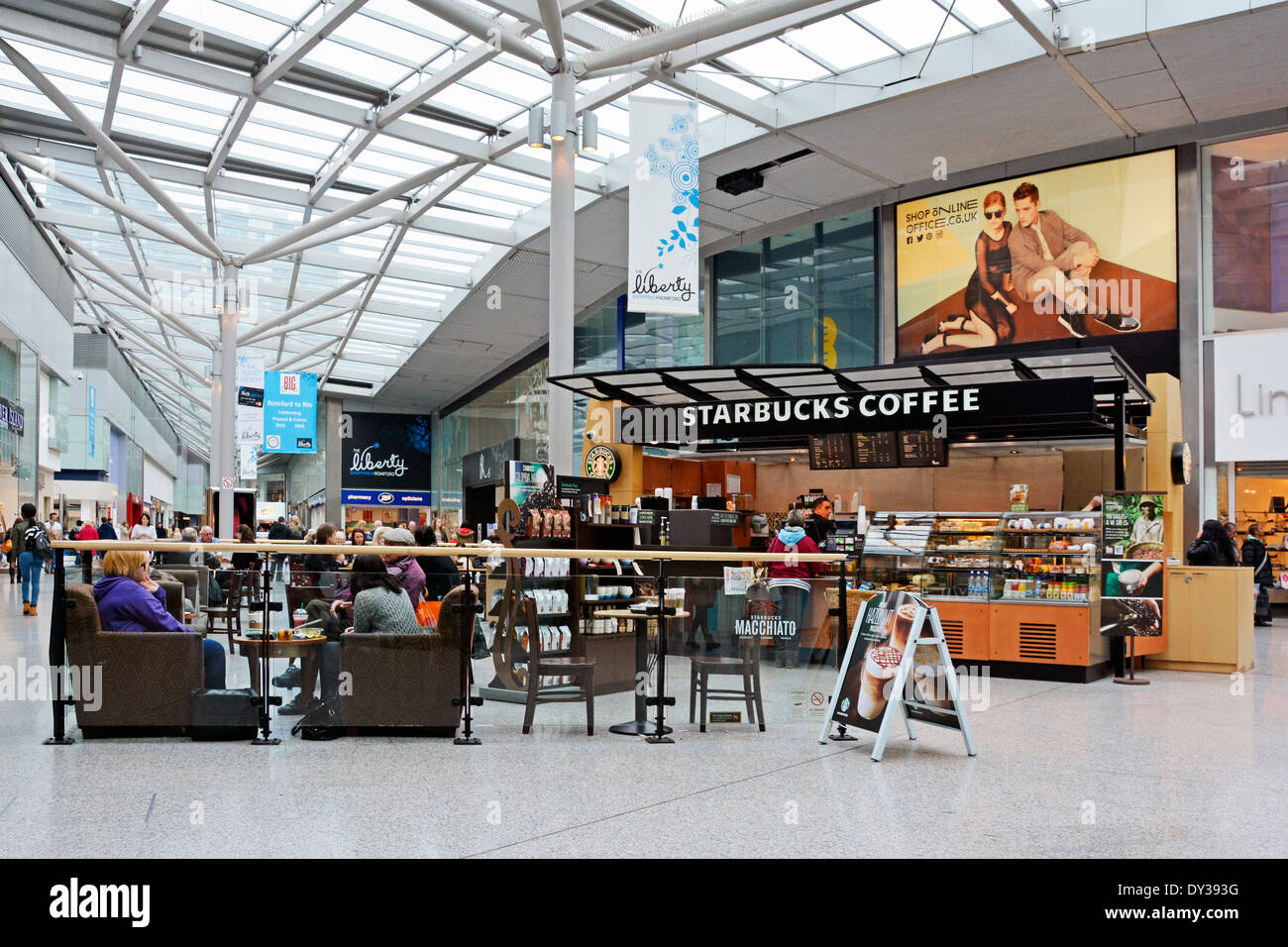 Starbucks Coffee shop with large wall mounted advertising panel in the ...