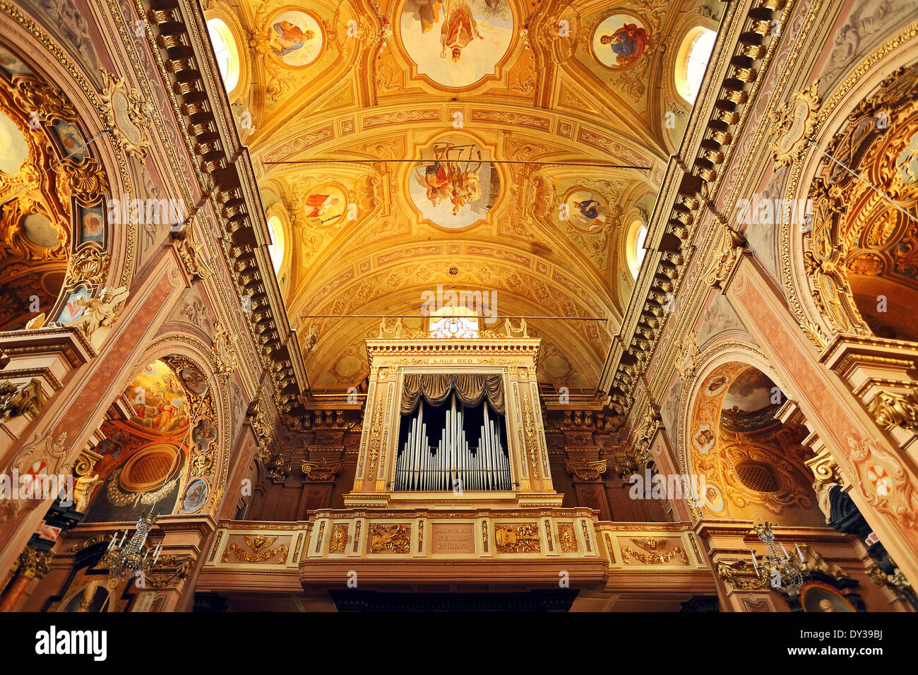 Organ and fragment of ornate ceiling as part of catholic church ...