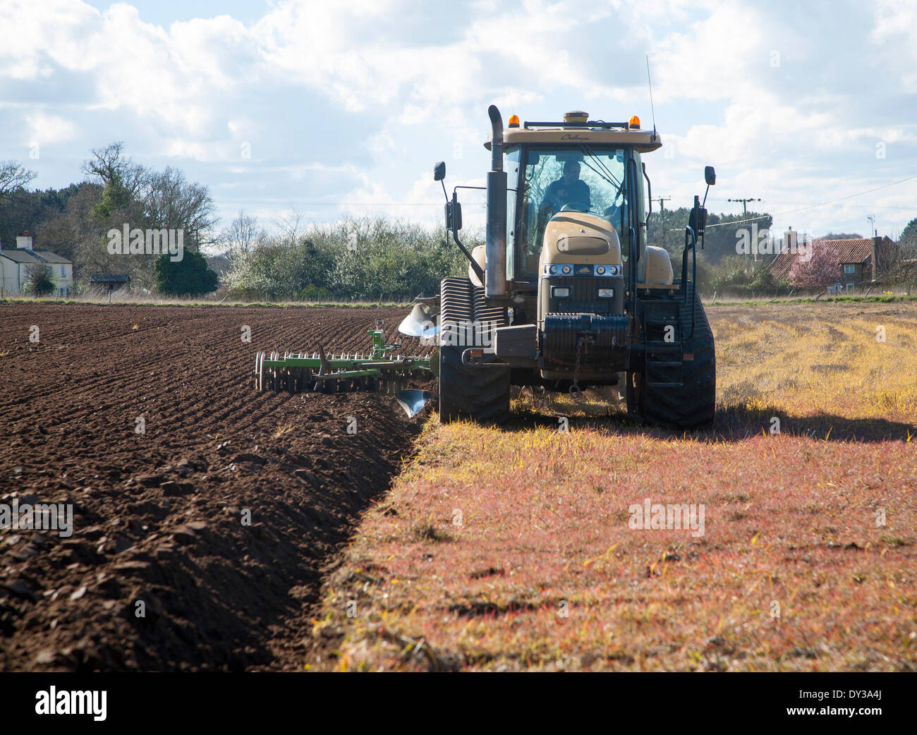 Challenger tracked tractor ploughing and pressing the soil in an arable ...