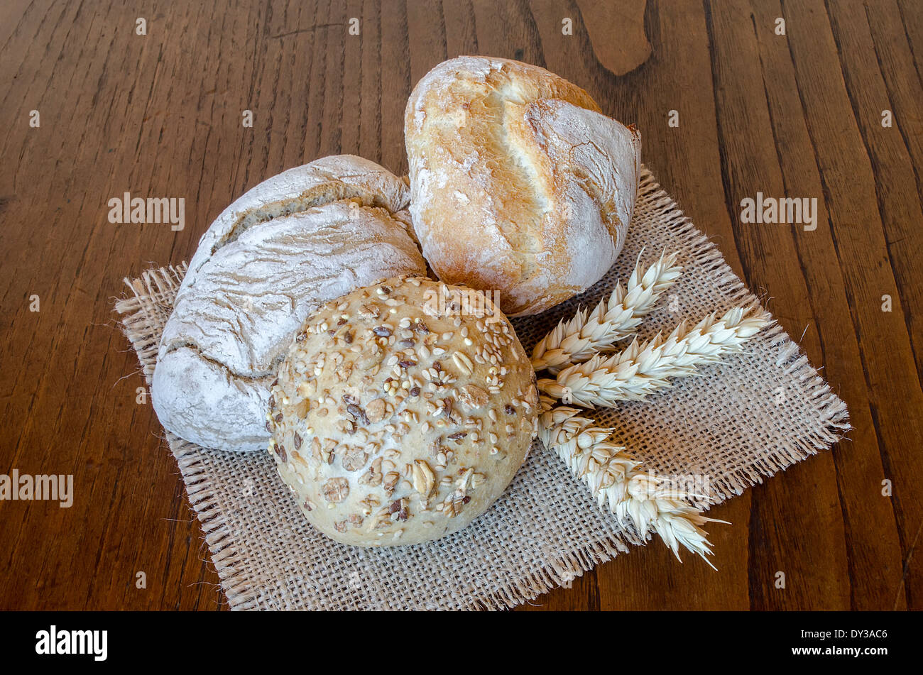 bread rolls of different varieties, baked goods, on the rustic table ...
