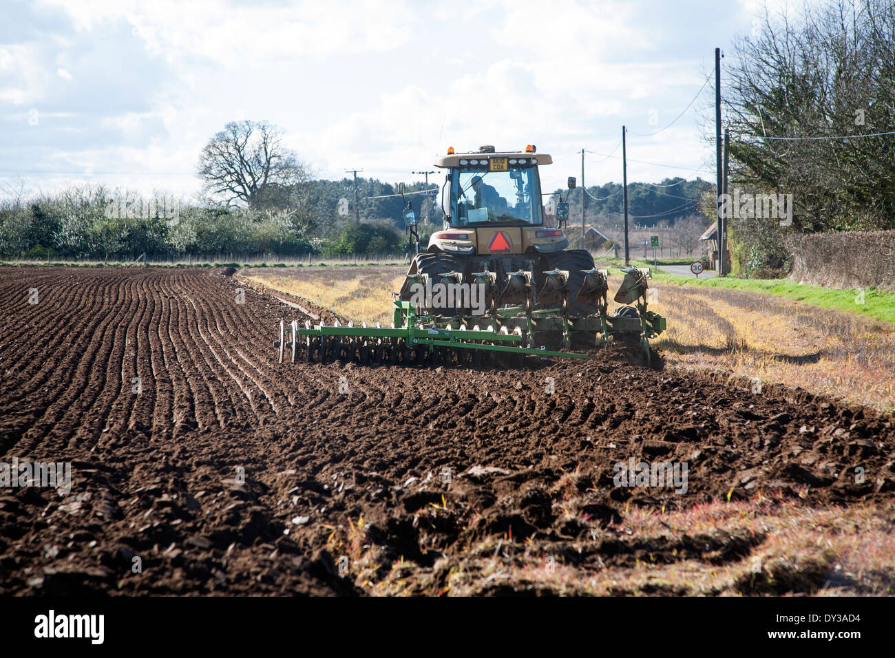 Challenger tracked tractor ploughing and pressing the soil in an arable ...