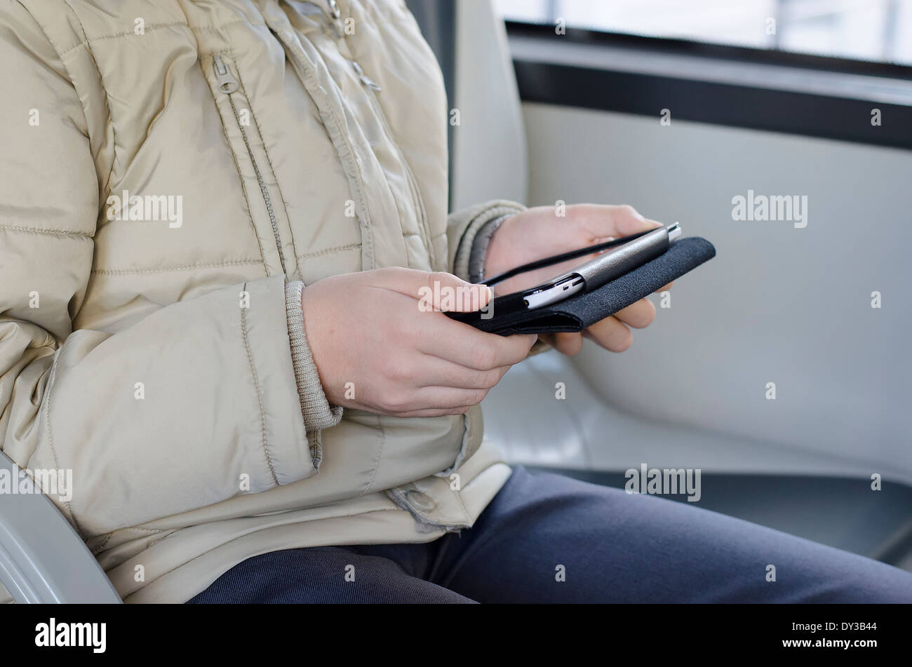 Boy playing with the digital tablet in a school bus Stock Photo - Alamy