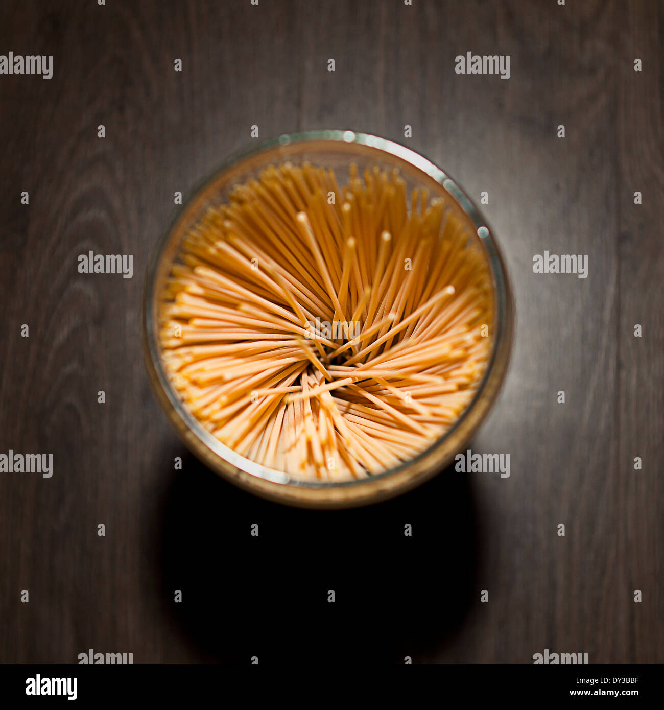 Traditional bronze spaghetti pasta in a jar. Close up, square format ...