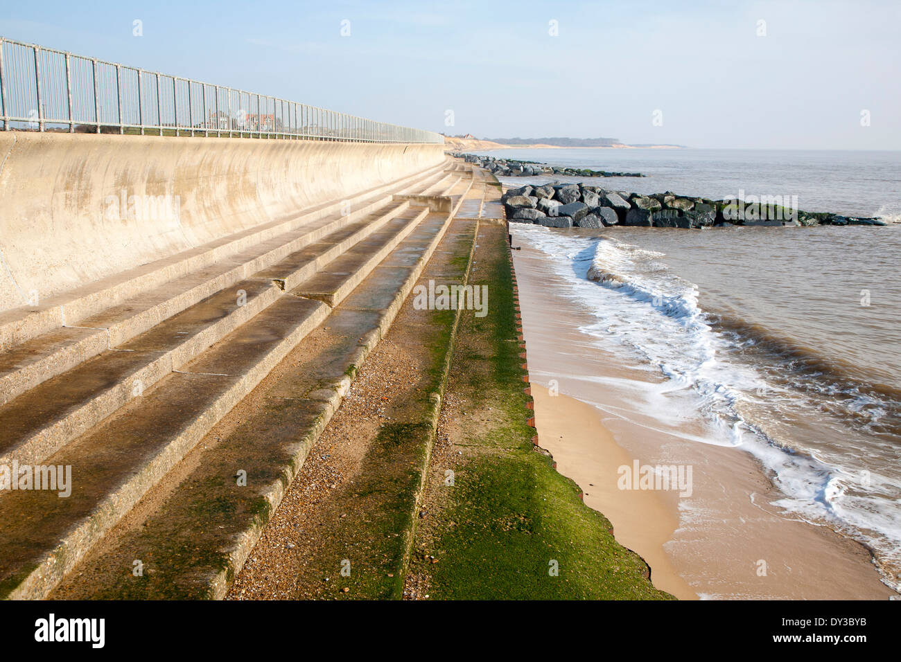Curved Sea wall, steps and rock armour groynes, forming coastal ...