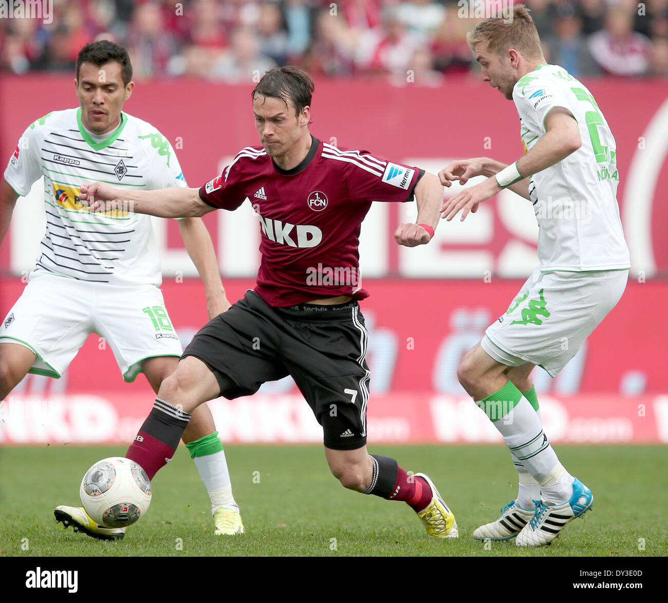 Nuremberg, Germany. 05th Apr, 2014. Nuremberg's Markus Feulner (C) vies ...