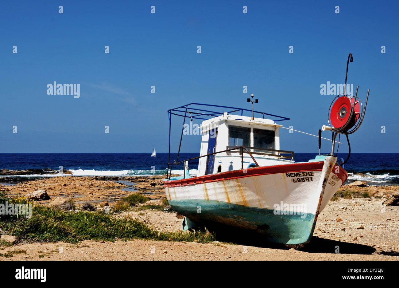 Beach scene with traditional Cypriot / Greek fishing boat Stock Photo ...