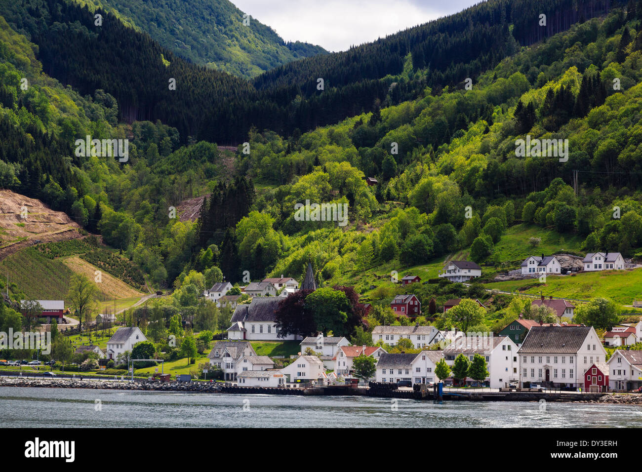 Offshore view across Hardangerfjorden to ferry port and typical coastal ...