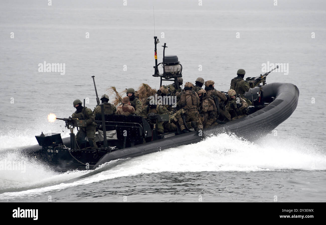 A team of German Navy frogmen pace in a military speed motor boat ...