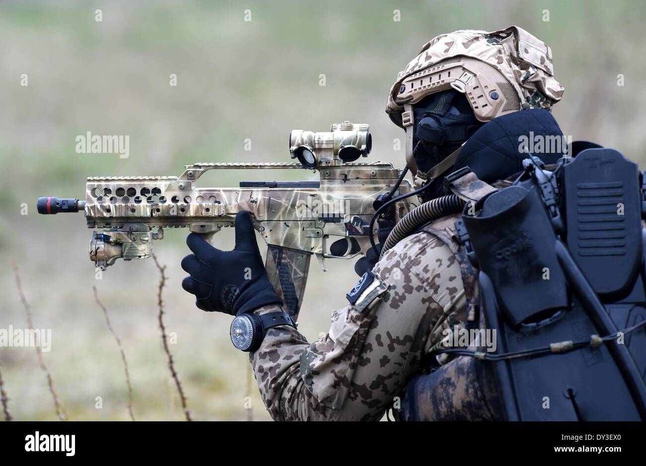 German Navy frogman shoots with his rifle during a military ...