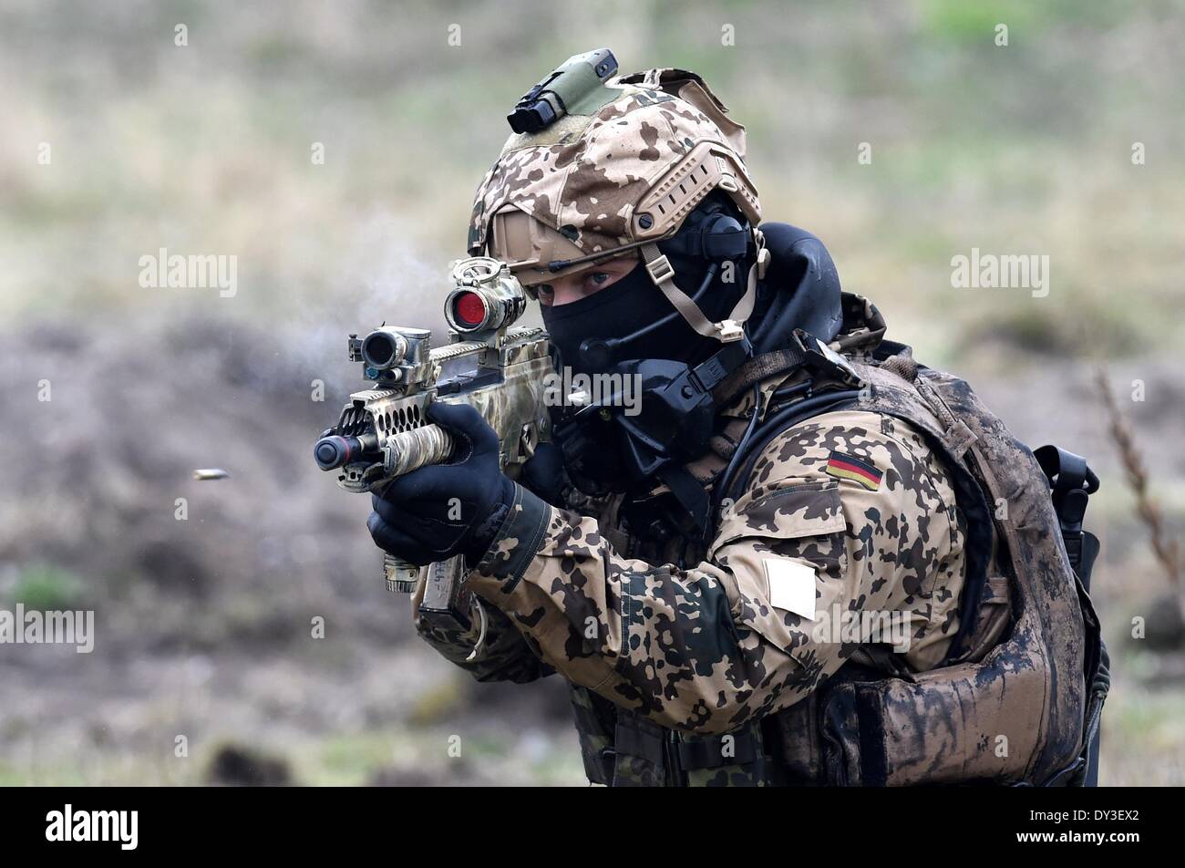 German Navy frogman shoots with his rifle during a military ...