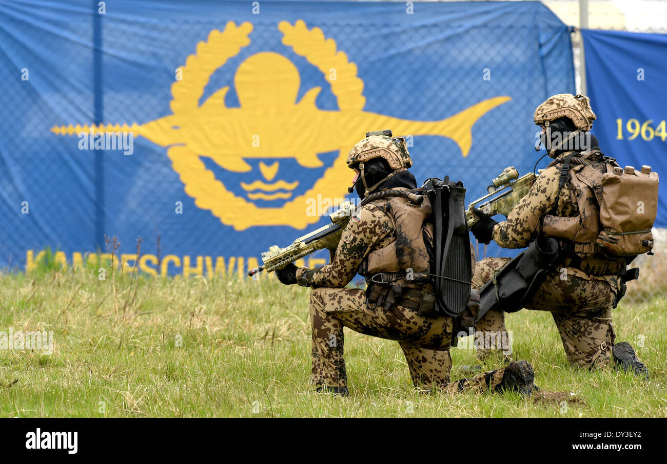 Eckernfoerde, Germany. 5th Apr, 2014. Two German Navy frogmen kneel ...