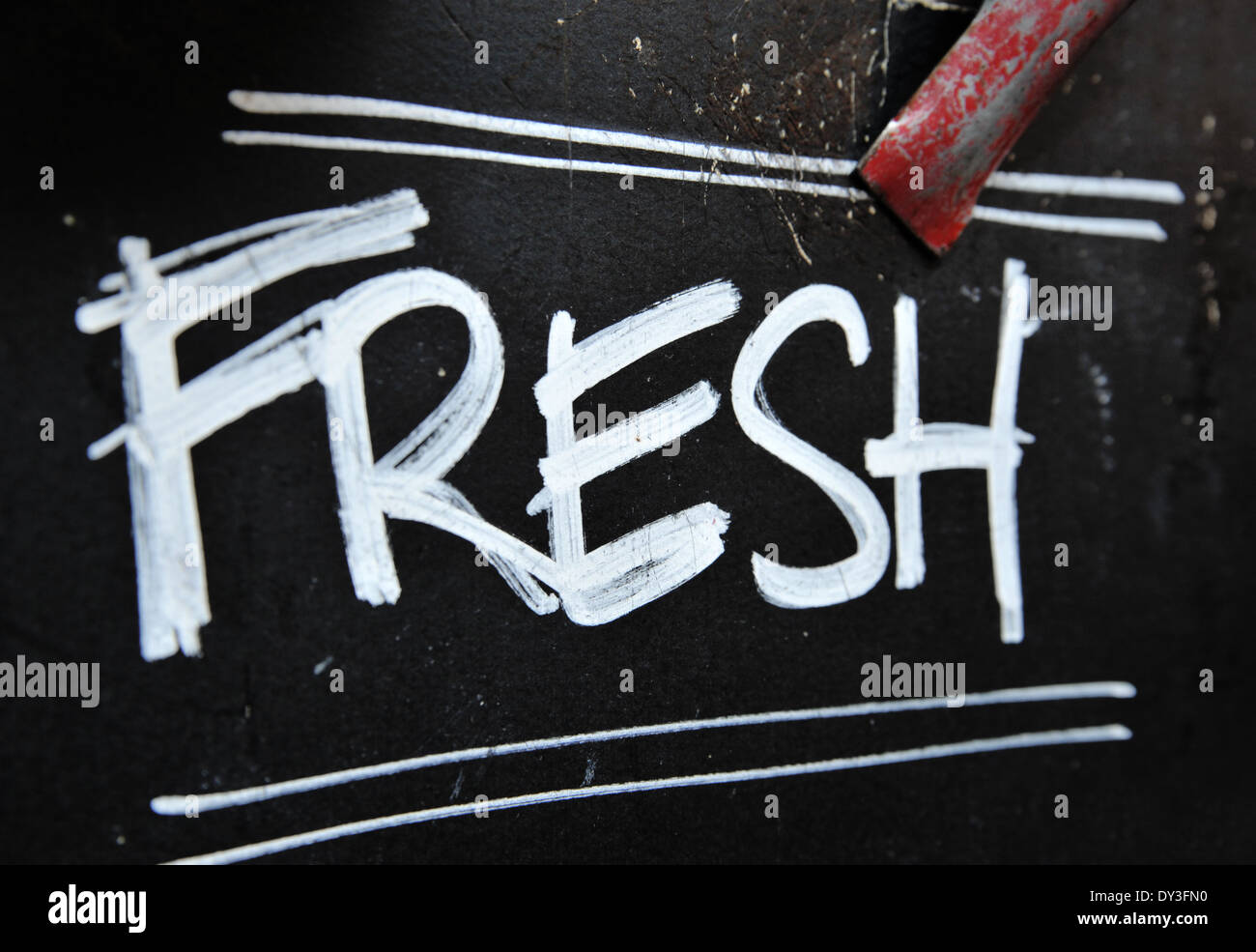 A chalkboard market sign with handwritten word stating FRESH Stock ...