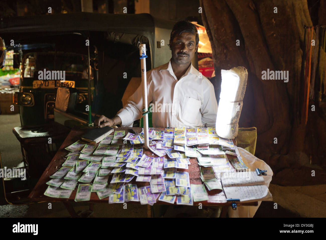 Kandy, Sri Lanka. Lottery ticket seller at night Stock Photo - Alamy