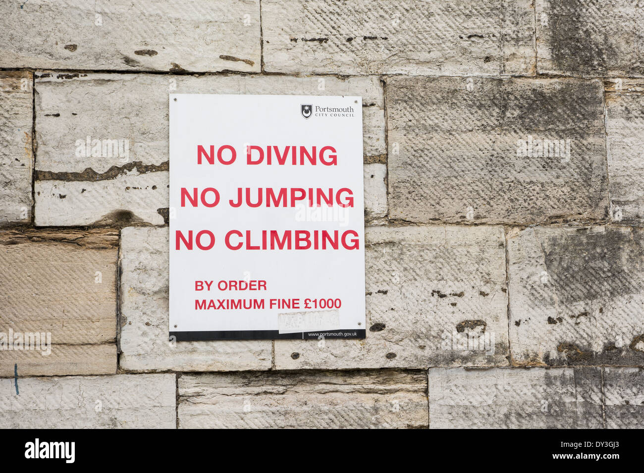 Warning sign on the side of a building Stock Photo - Alamy