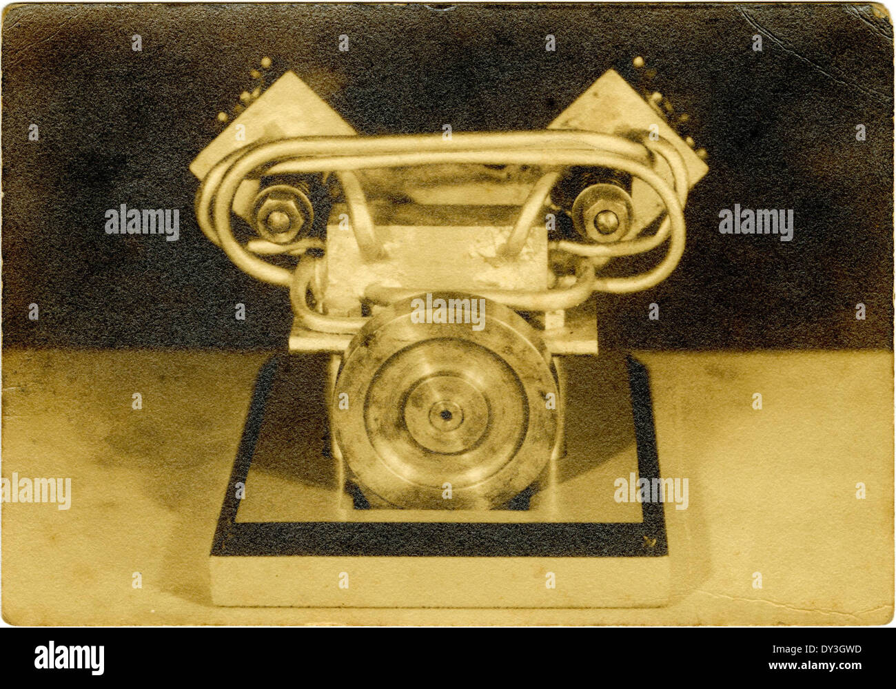 Photograph of a metal mechanical compressor device, illustrating the ...