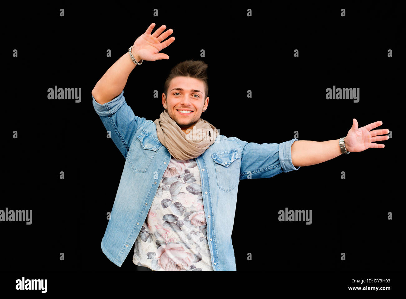 Cheerful young man dancing, moving arms up in the air, isolated on ...