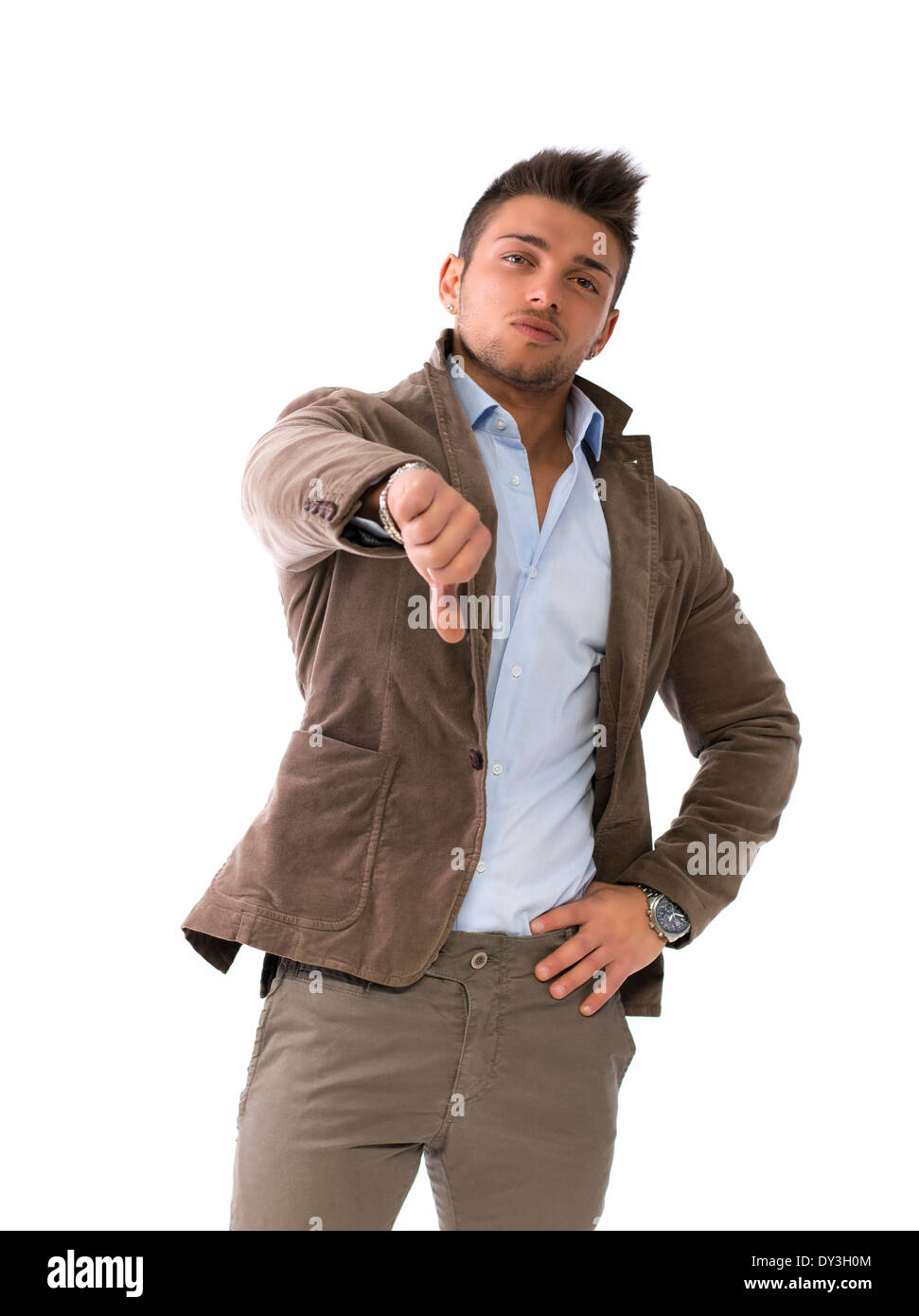 Handsome young man doing thumb down sign with hand, isolated on white ...
