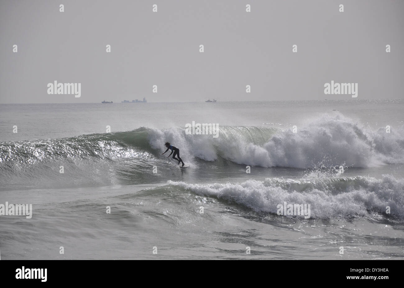 Surfer in the waves at Barceloneta beach, Barcelona, Spain Stock Photo ...