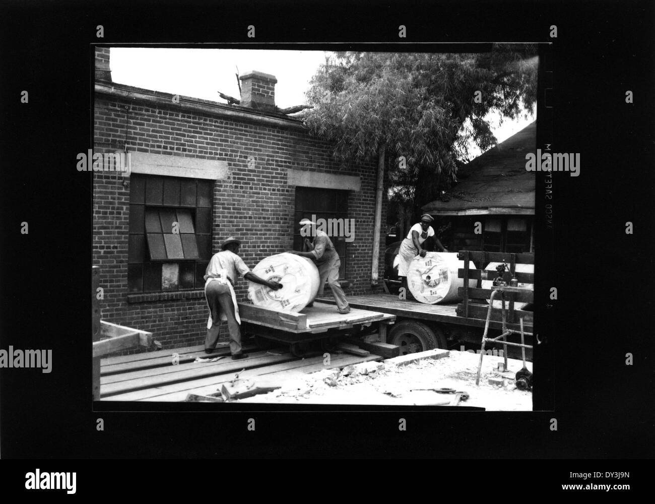 This image shows the loading and unloading of paper rolls at H.L. Green ...